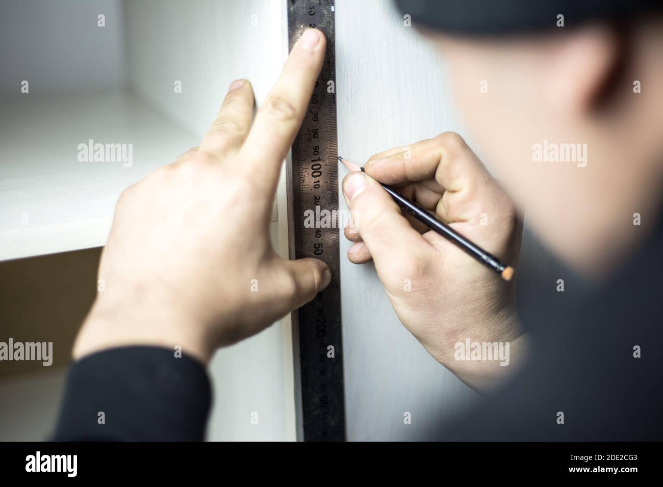 Carpenter hands taking measurement with pencil of wooden plank. Concept ...