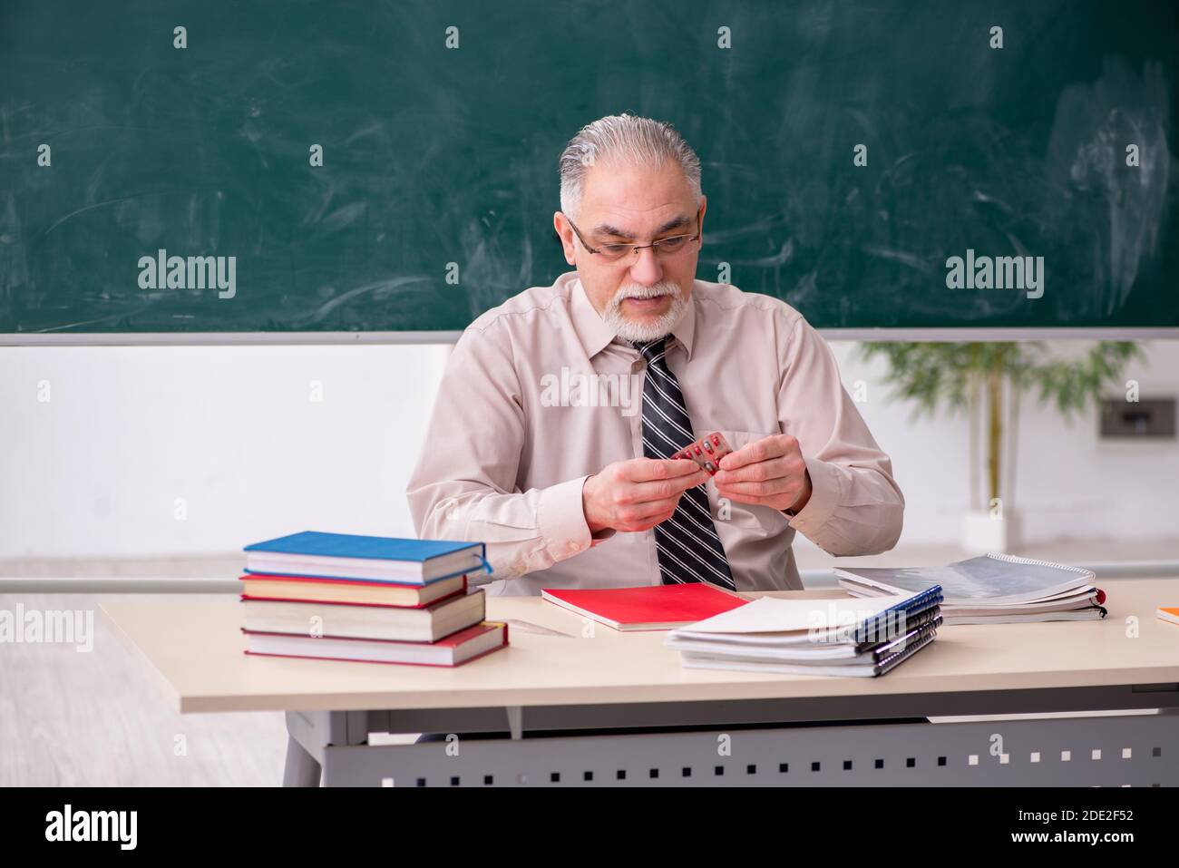 Old experienced teacher in the classroom Stock Photo - Alamy