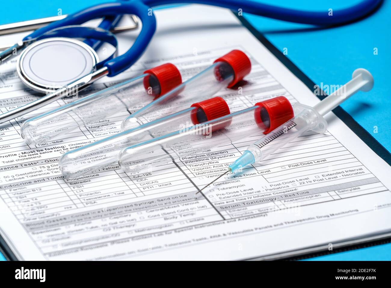 Clipboard with paper blank form with medical tools on blue background ...