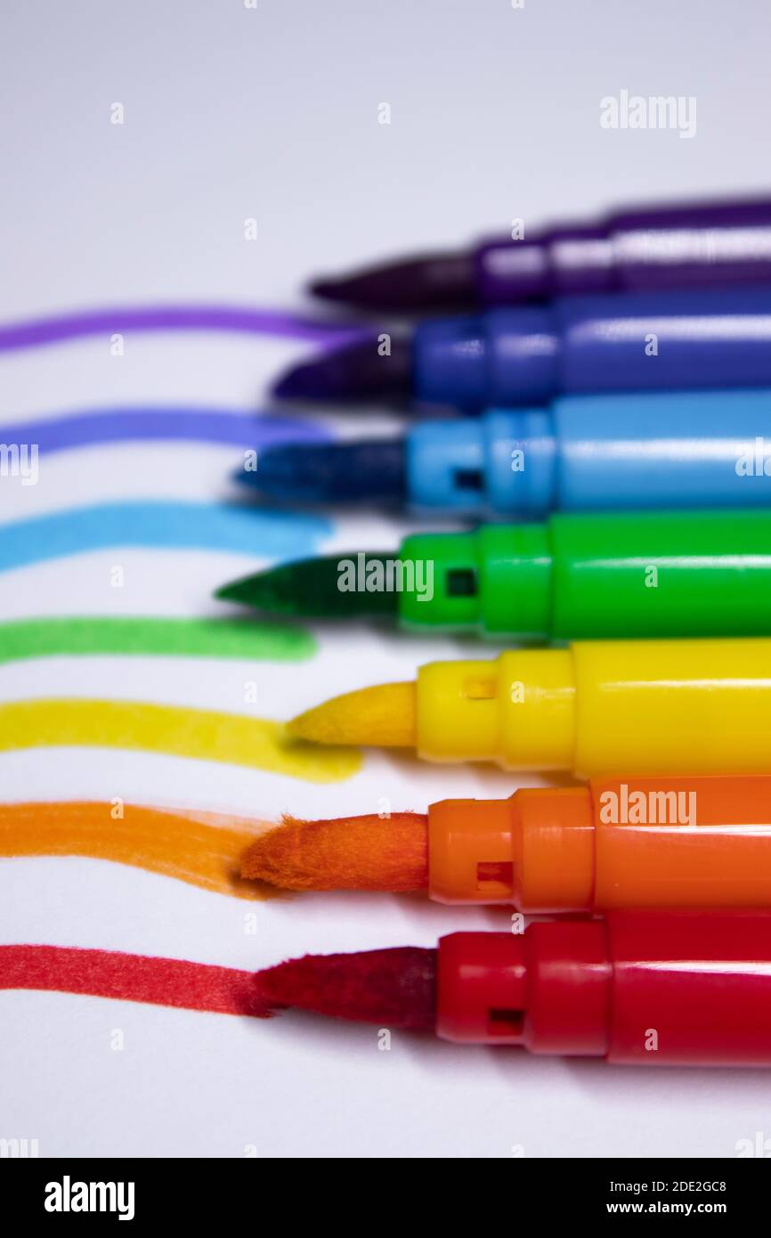 a bunch of colored markers laid out in rainbow order. stationery ...