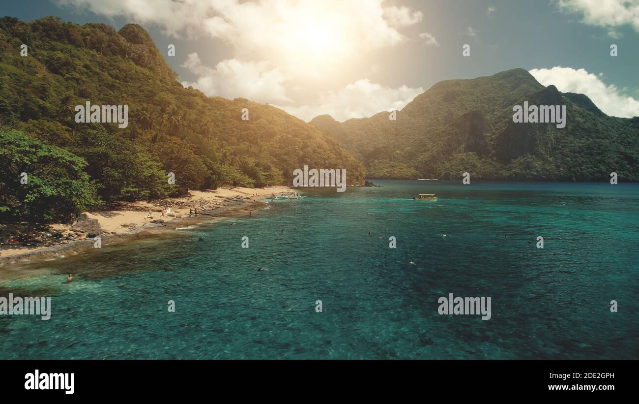 Sun sand beach at ocean aerial. Traveling boat on water surface ...