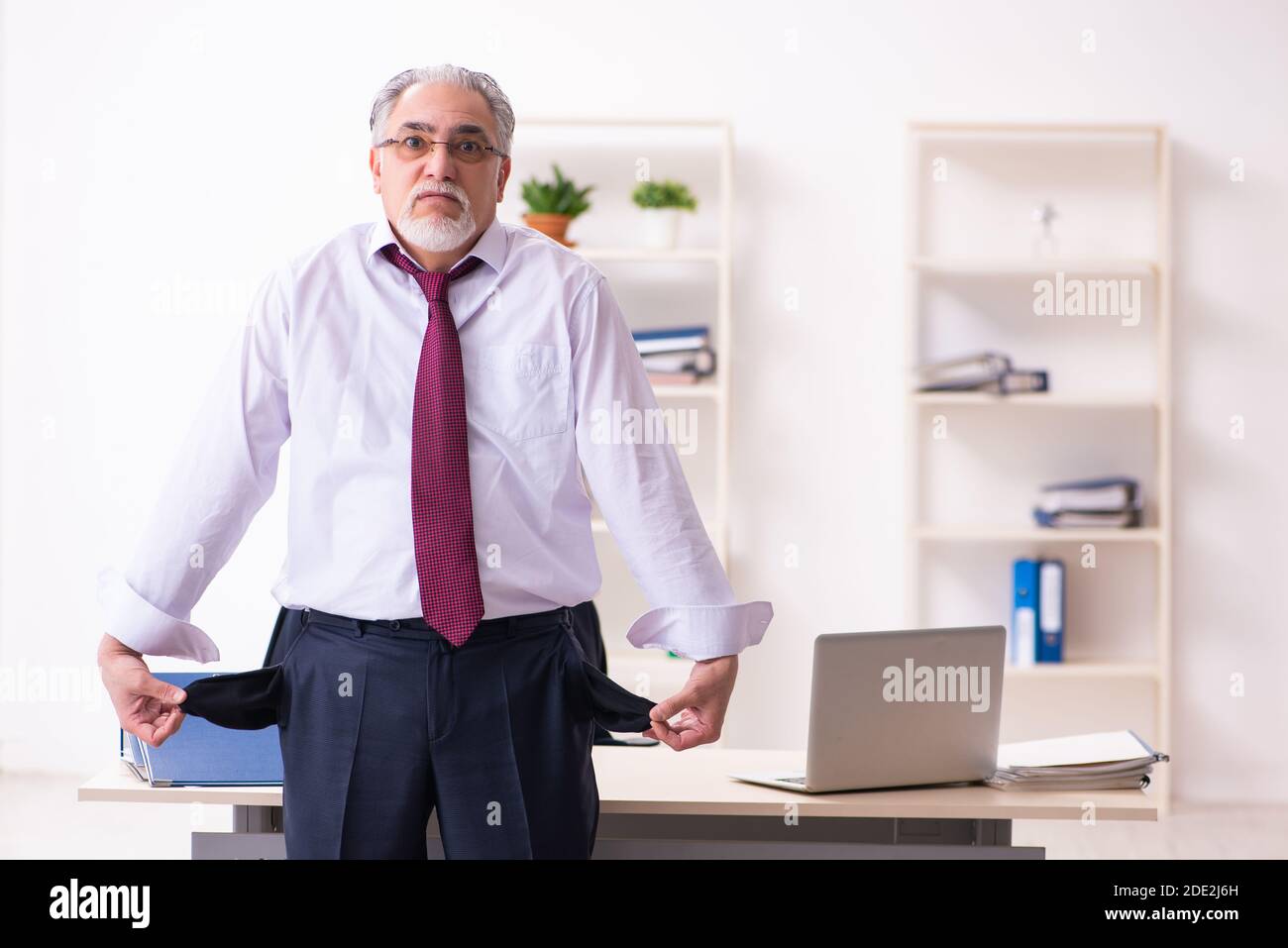 Old businessman in bankruptcy concept Stock Photo - Alamy