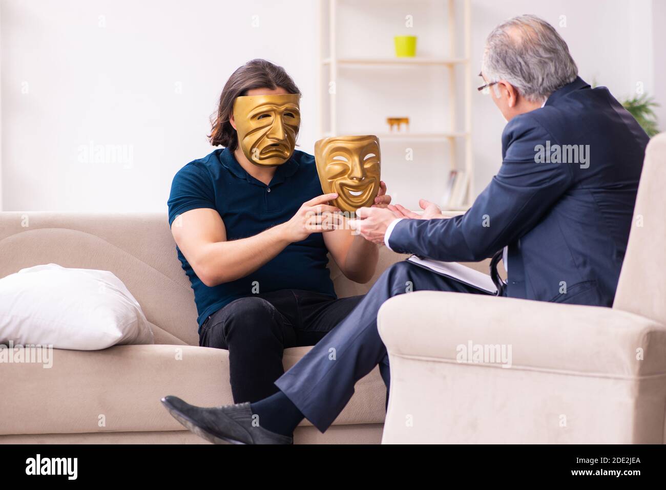 Man wearing masks during psychotherapy session Stock Photo - Alamy
