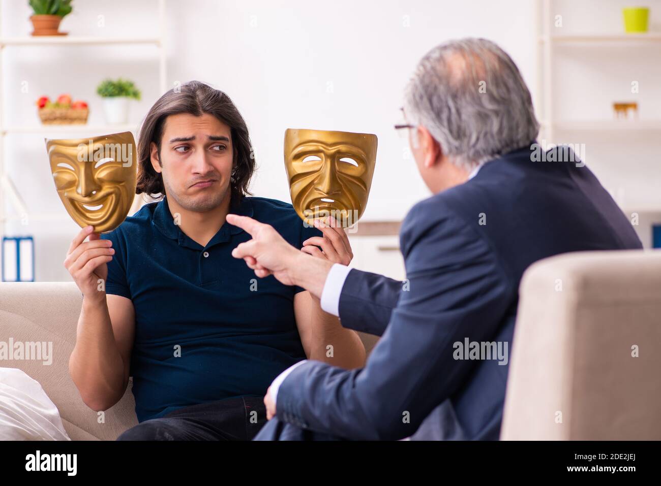 Man wearing masks during psychotherapy session Stock Photo - Alamy