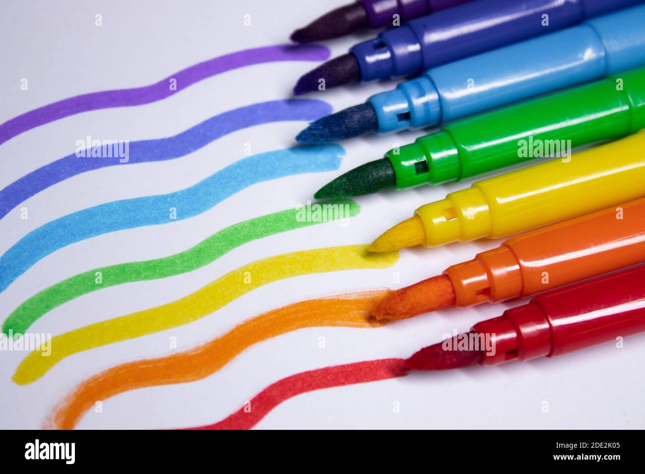a bunch of colored markers laid out in rainbow order. stationery ...