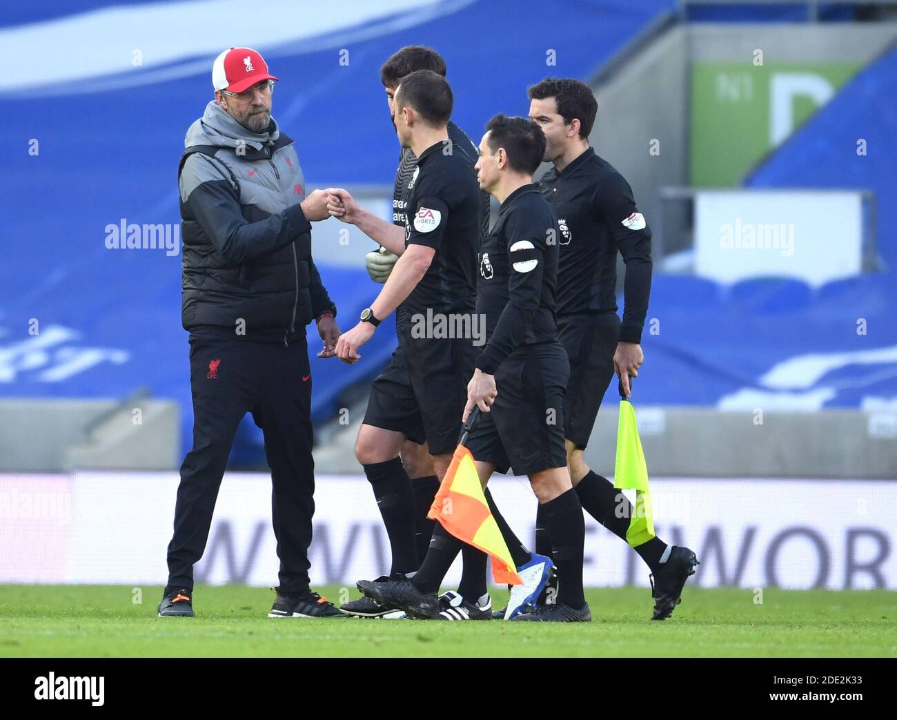 Liverpool manager Jurgen Klopp (left) fist bumps the match officials ...