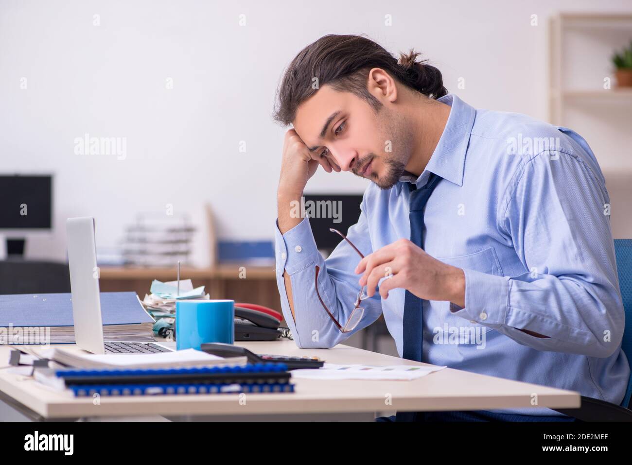 Sick male employee suffering at the workplace Stock Photo - Alamy