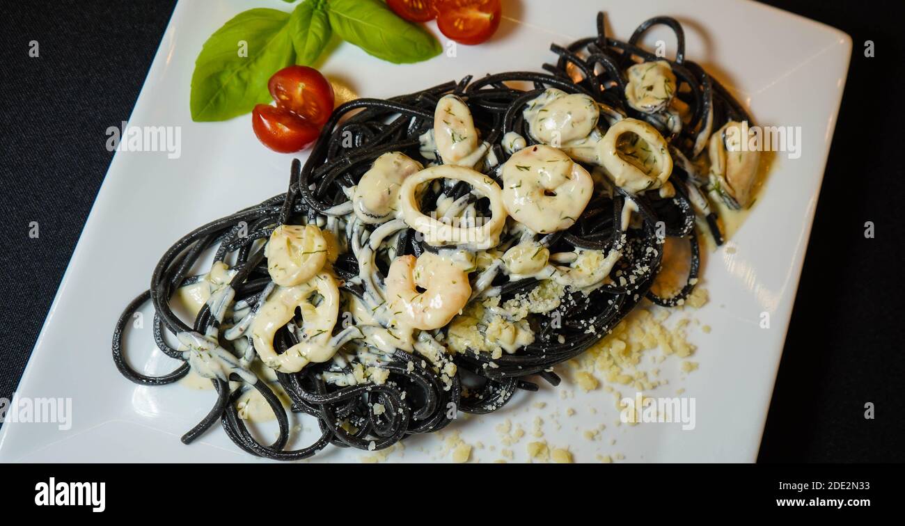 Spaghetti Rigate - black pasta with mixed seafood Stock Photo - Alamy