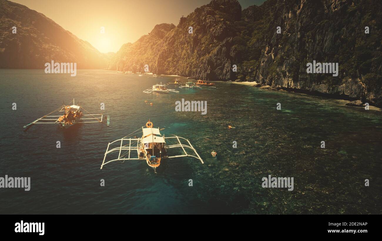 Sunset at closeup passenger boats at cliff ocean shore aerial view ...
