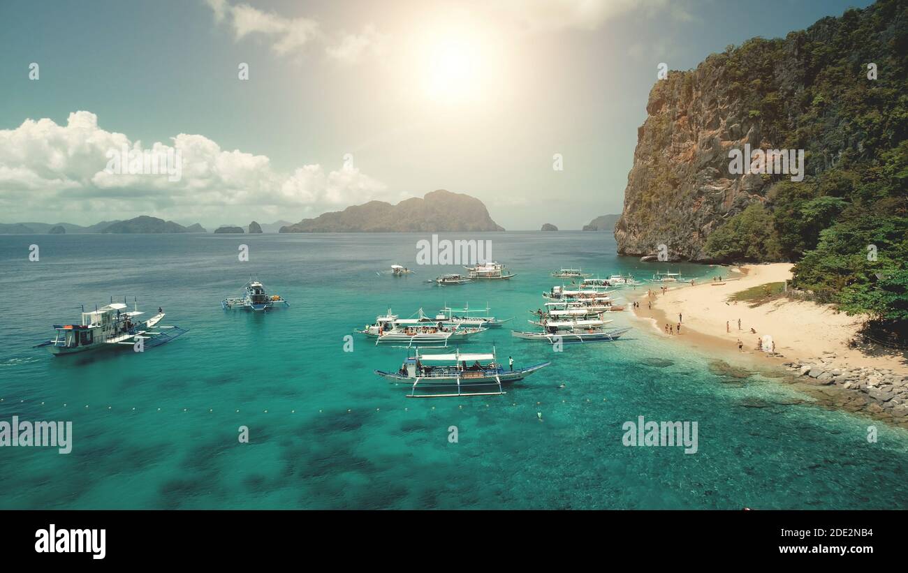 Passenger ship at sea coast with green cliff shore. Sun tropical ...