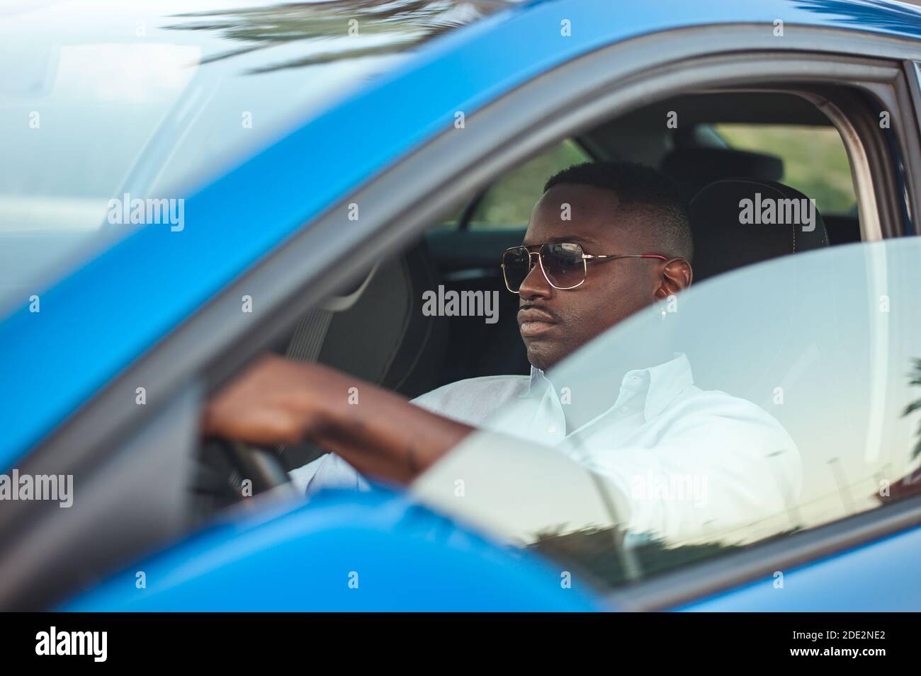 Black man driving his new car Stock Photo - Alamy