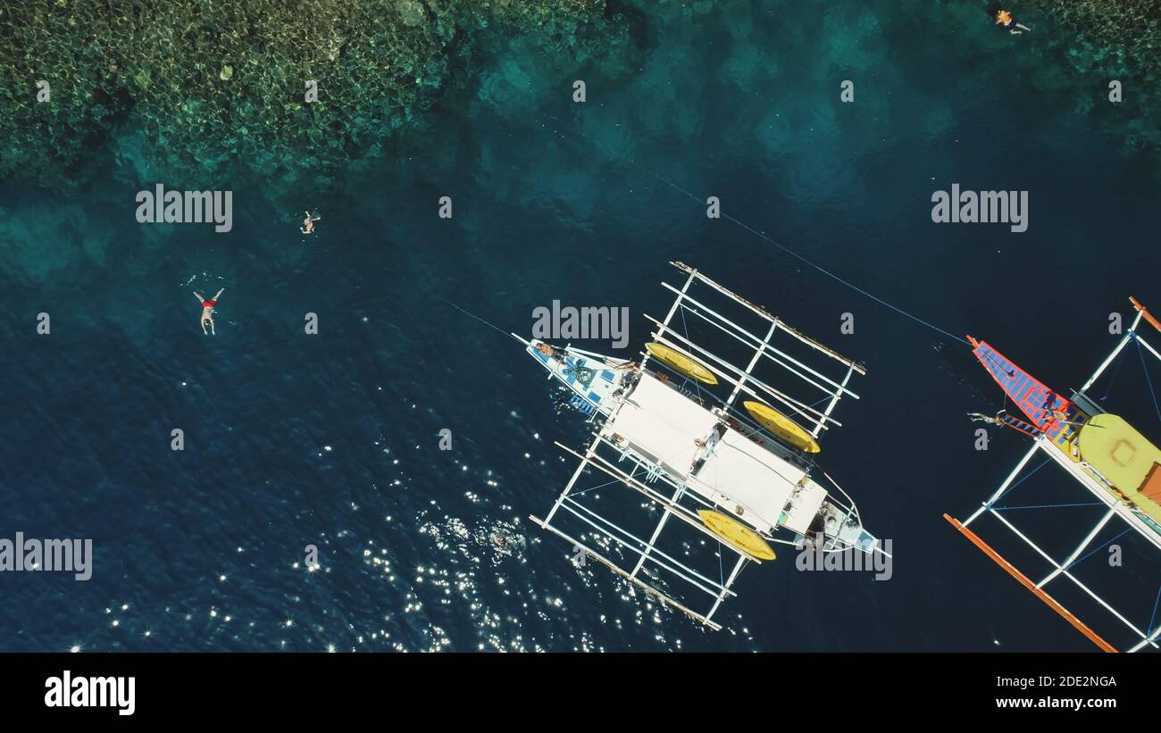 Top down aerial view of boats at cliff ocean shore, sand beach. Nature ...