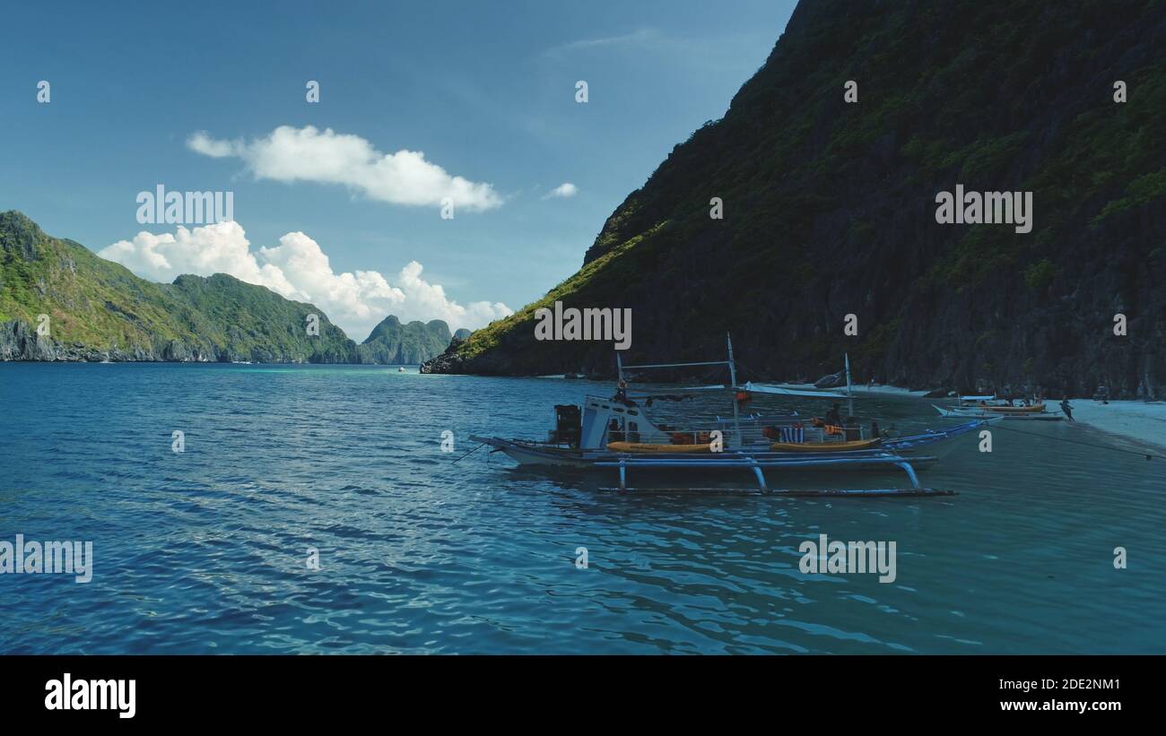 Closeup passengers boats at ocean coast with cliff shore at summer tour ...