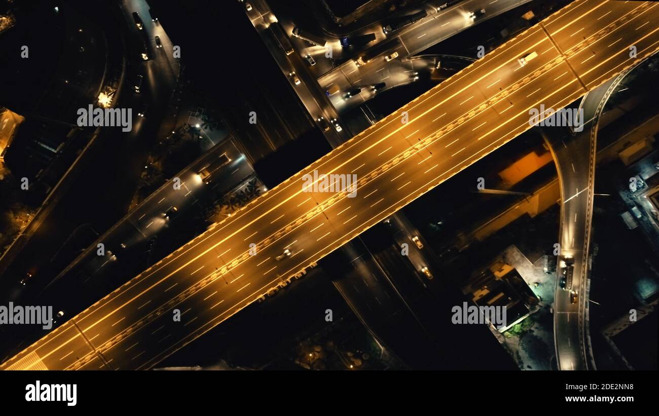 Top down of traffic road lit by lanterns at night illuminate aerial ...