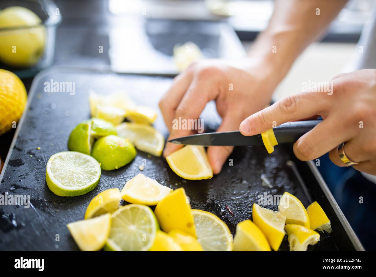Male hands slicing lemons hi-res stock photography and images - Alamy