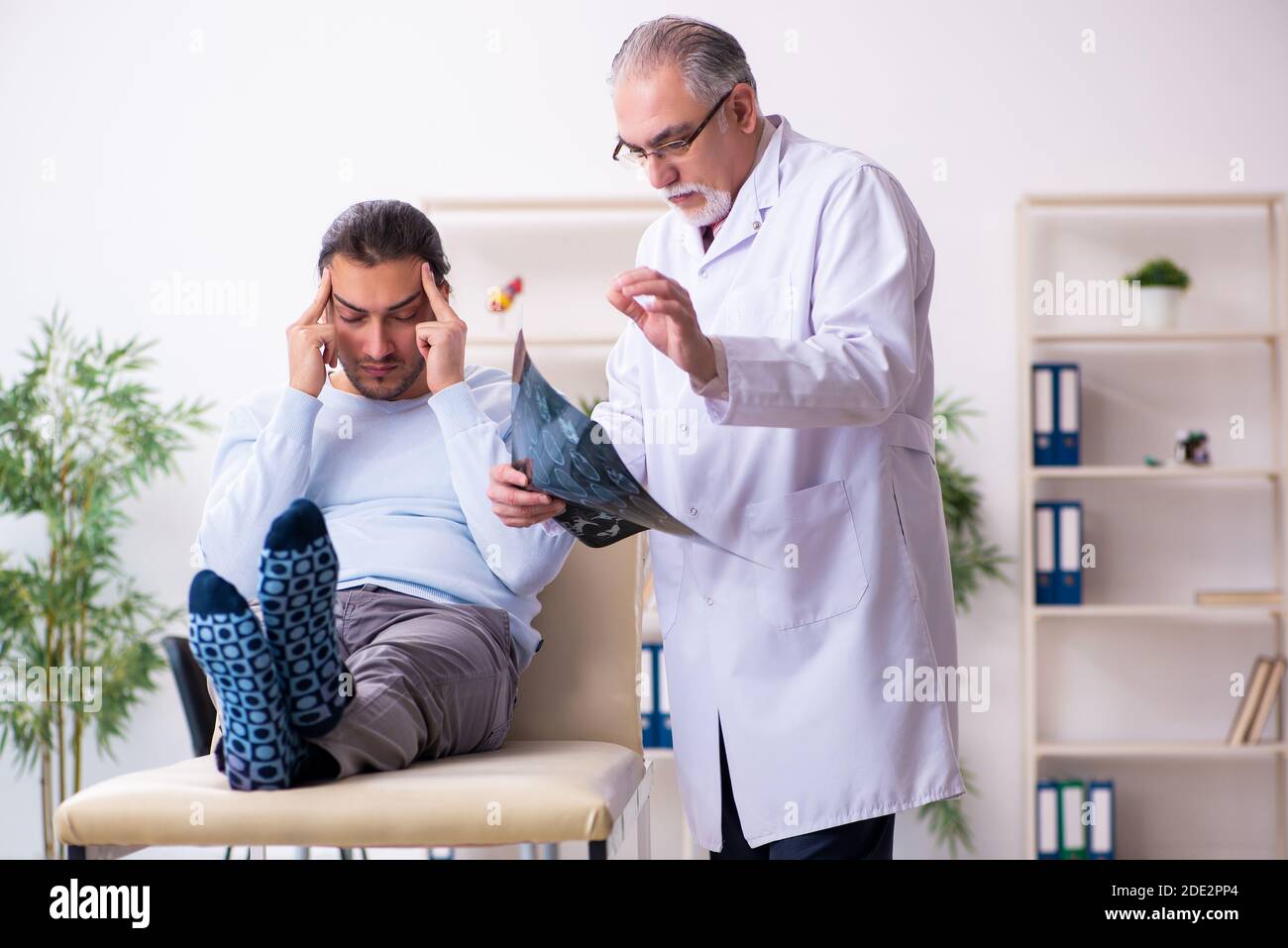 Sick man visiting old doctor radiologist Stock Photo - Alamy