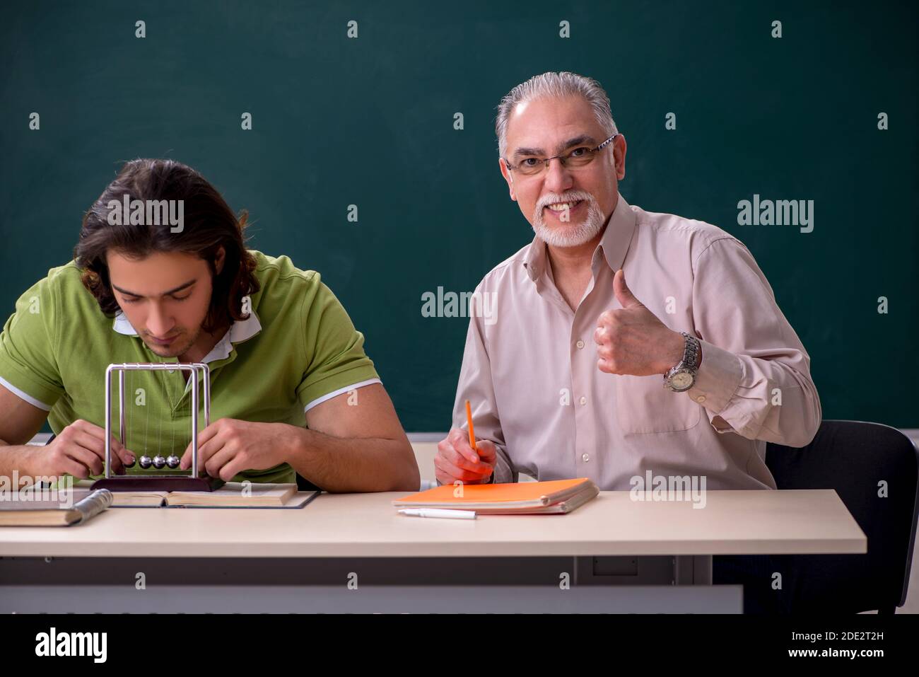Old professor physicist and student in the classroom Stock Photo - Alamy