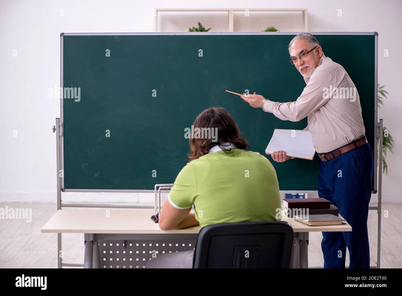 Old professor physicist and student in the classroom Stock Photo - Alamy