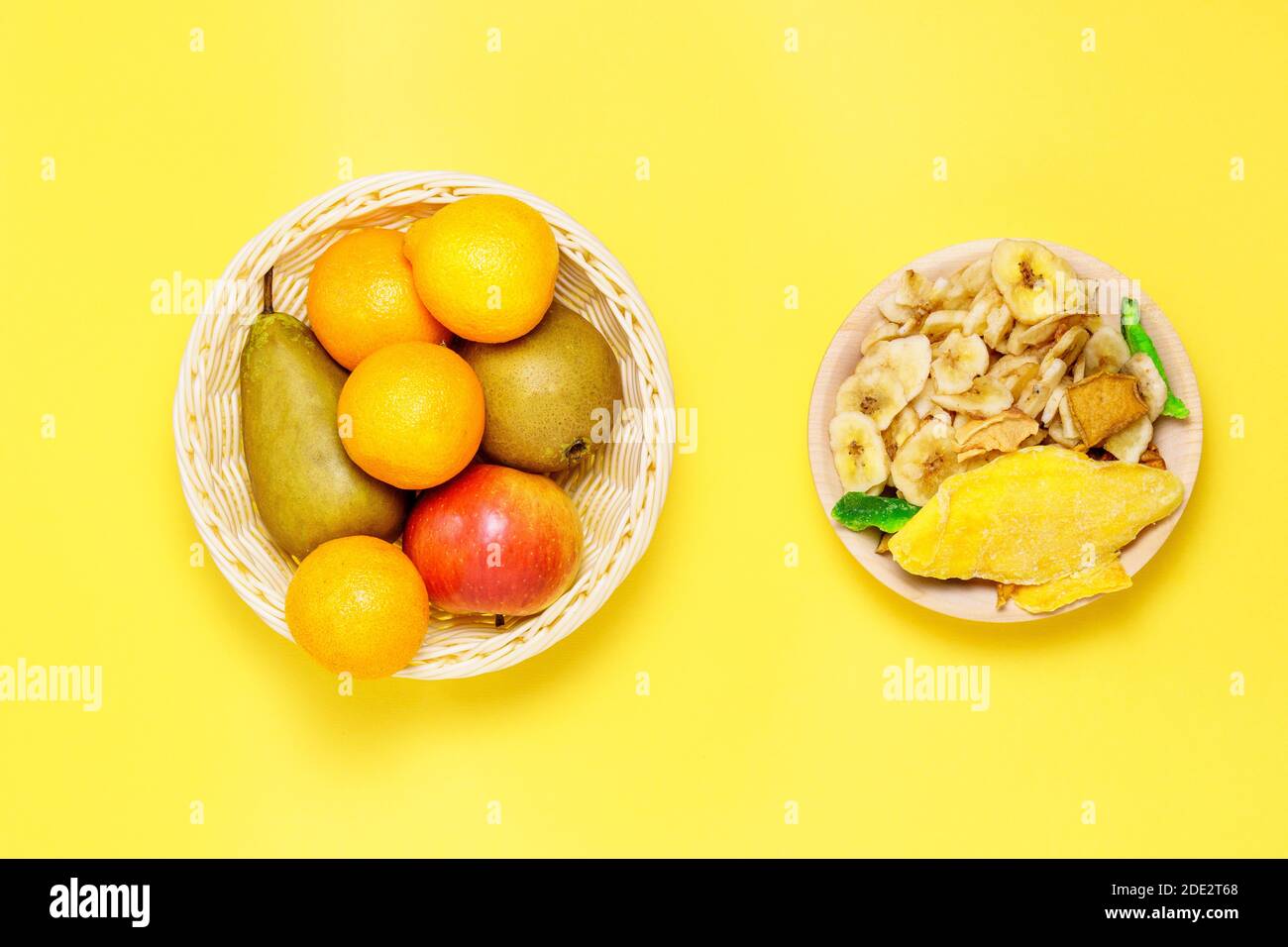 dried fruit and fruit on a yellow background top view. healthy snacks ...