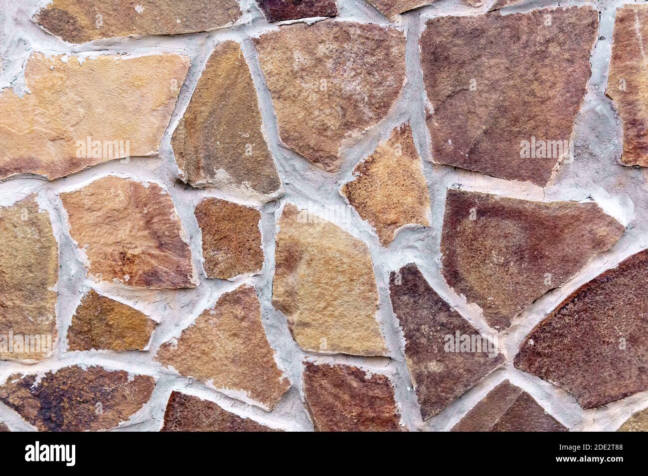 shaped stone wall creation, in various shades of brown. wallpaper ...