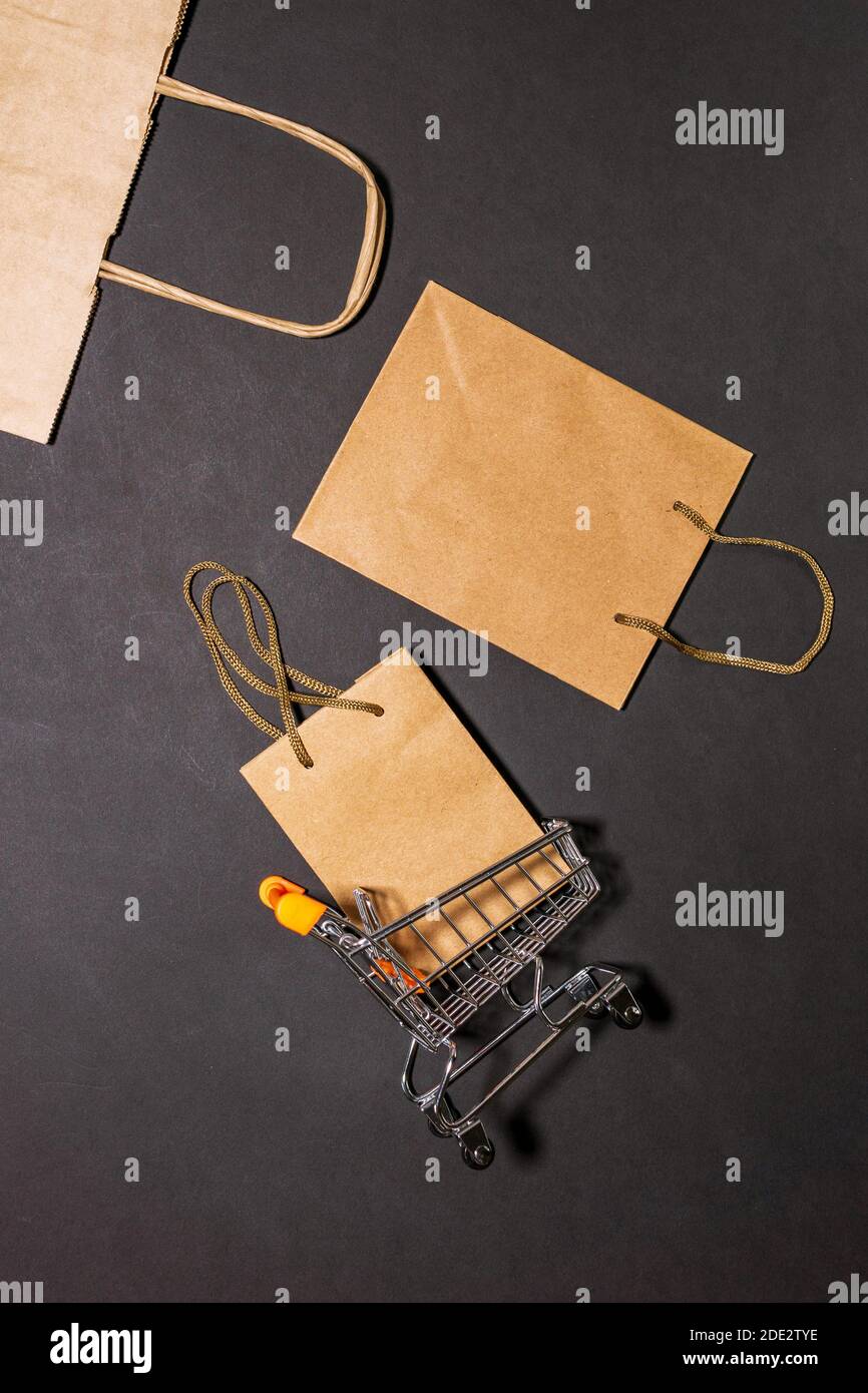 Eco paper bag with the inscription zero waste on black background, flat ...
