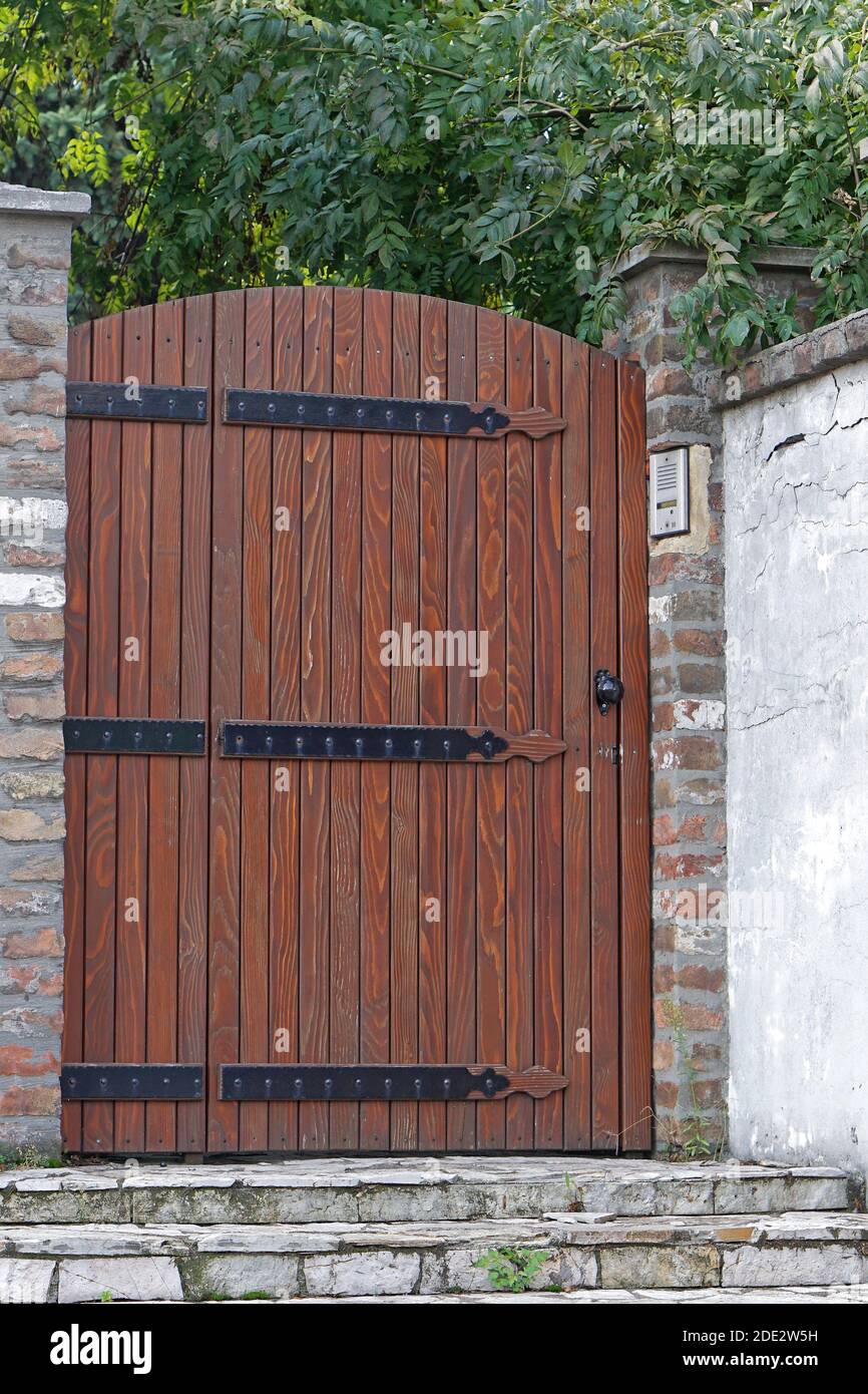 Closed brown wood gate at house fence Stock Photo - Alamy