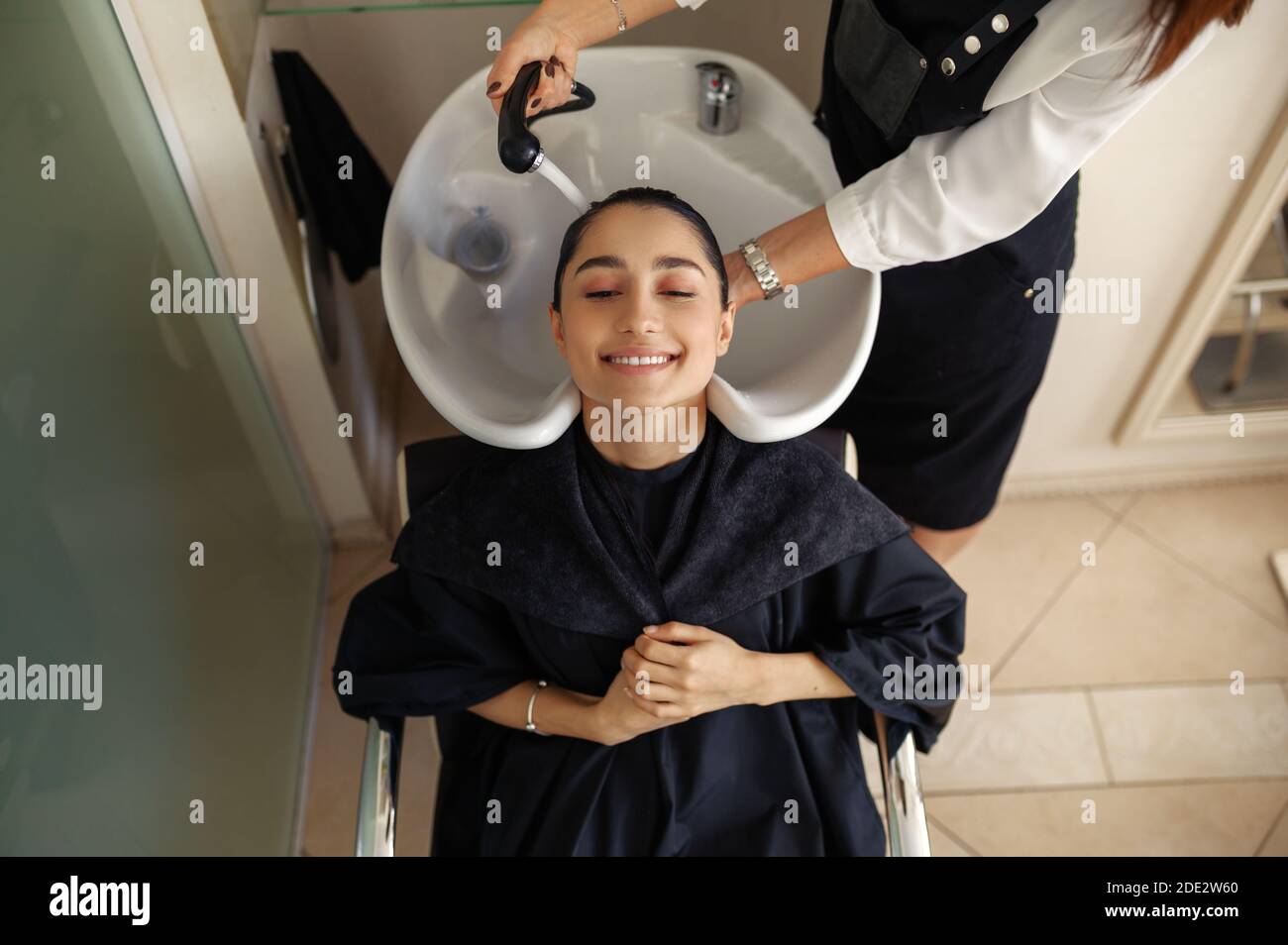 Female hairdresser washes client hi-res stock photography and images ...