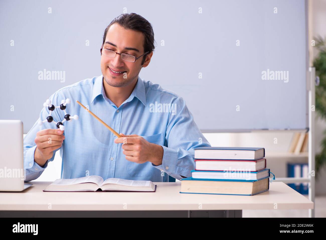 Young physics teacher in front of whiteboard Stock Photo - Alamy