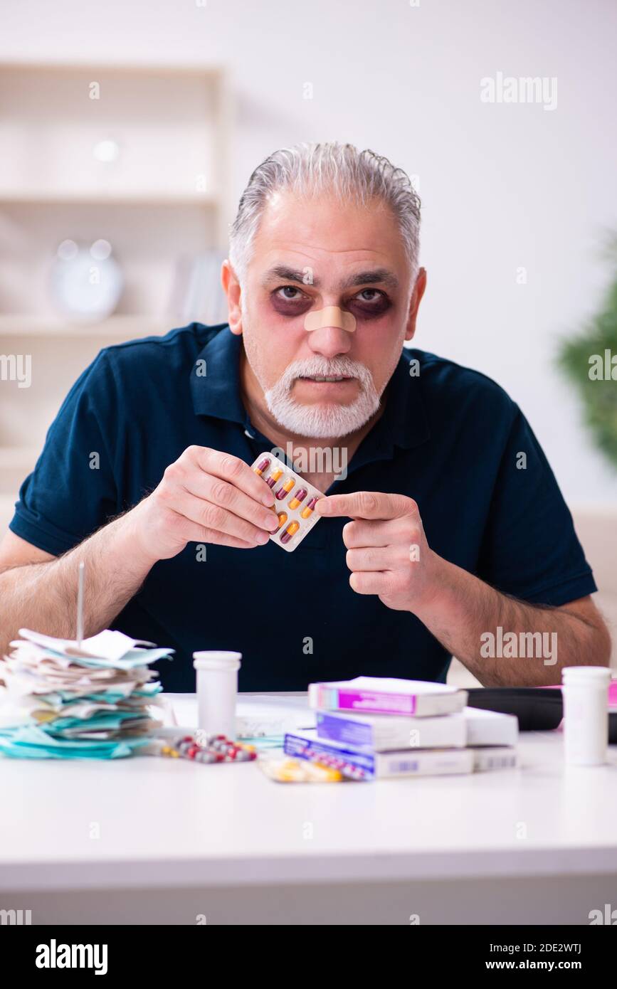 Old man in budget planning concept Stock Photo - Alamy