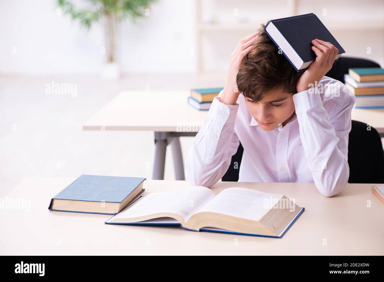 Schoolboy preparing for exam in the classroom Stock Photo - Alamy