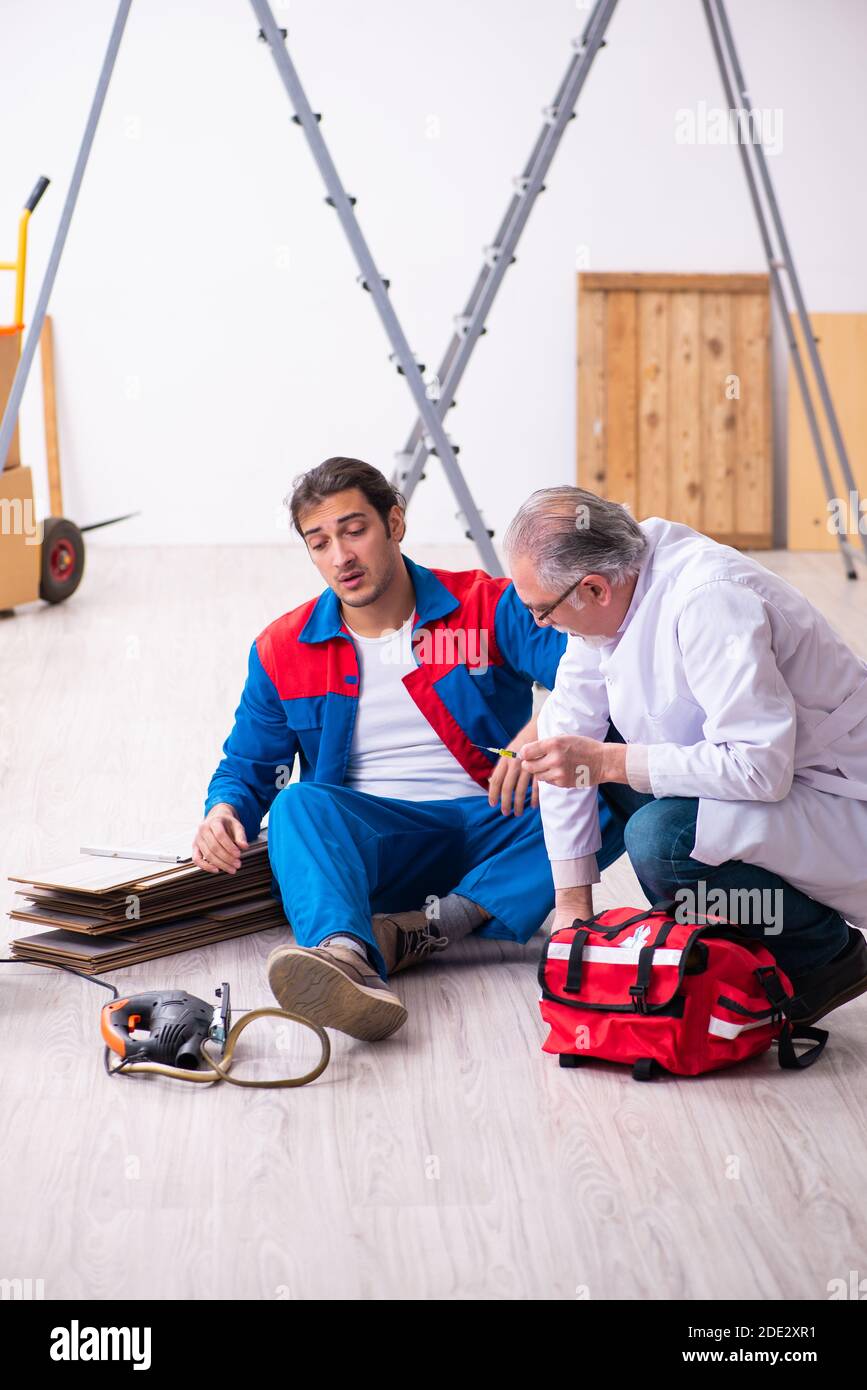 Experienced paramedic helping worker bitten by snake Stock Photo - Alamy