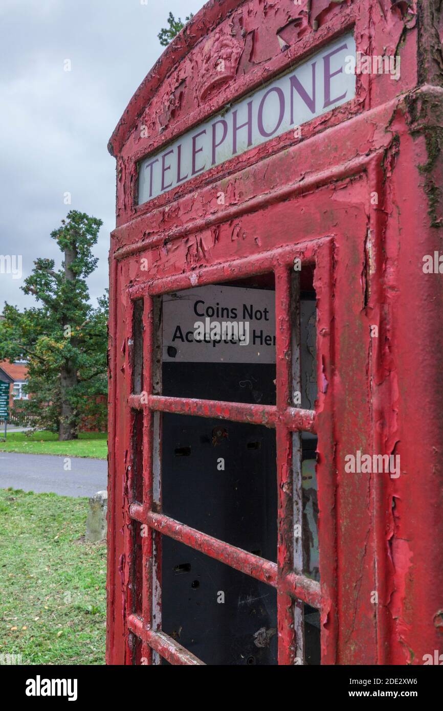 Abandoned old red phone box with broken smashed glass and peeling red ...
