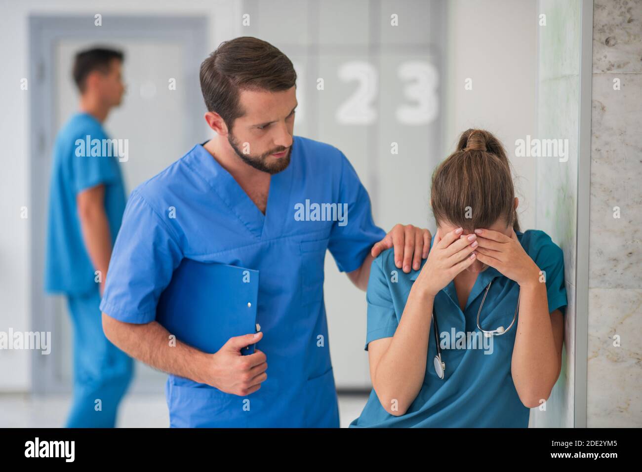 Female doctor feeling happy while her male colleague supporting her ...
