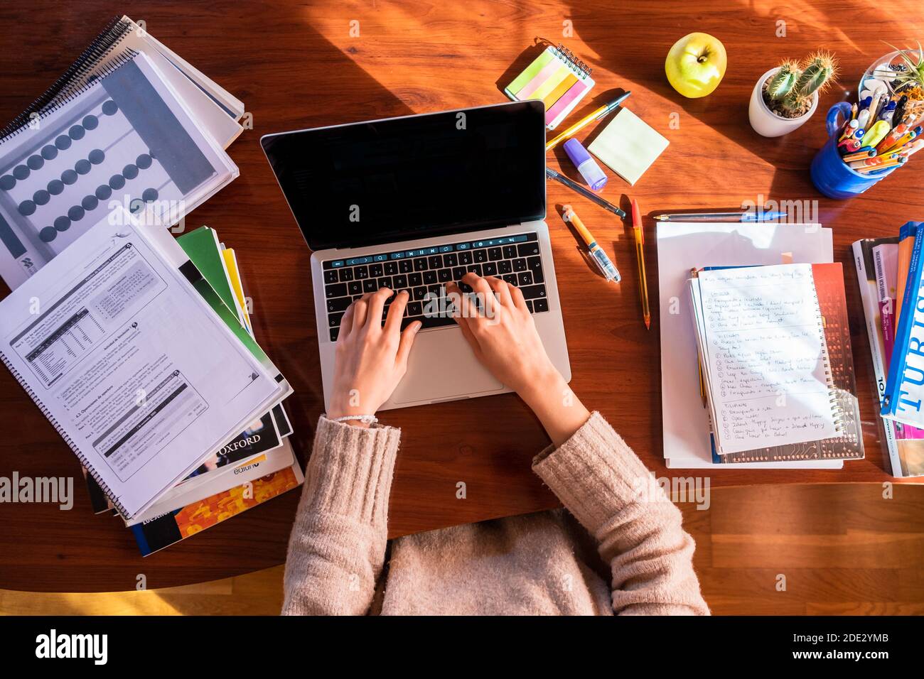 A top view shot of student's hands typing on the laptop, educational ...