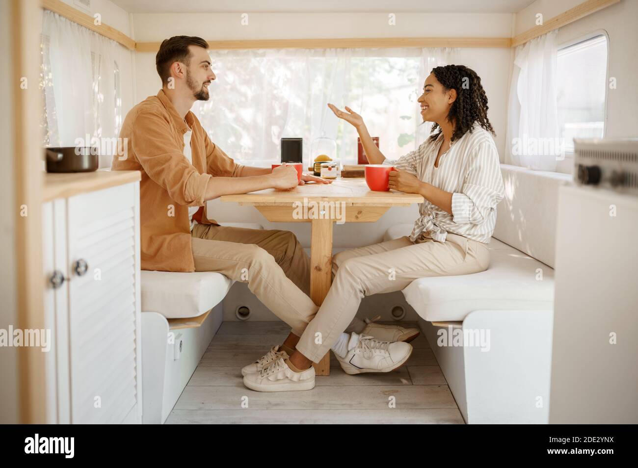 Love couple having breakfast in rv, camping Stock Photo - Alamy