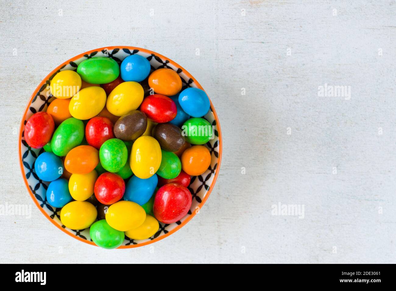 M&M's candy in the bowl on the white background, colorful candy texture ...