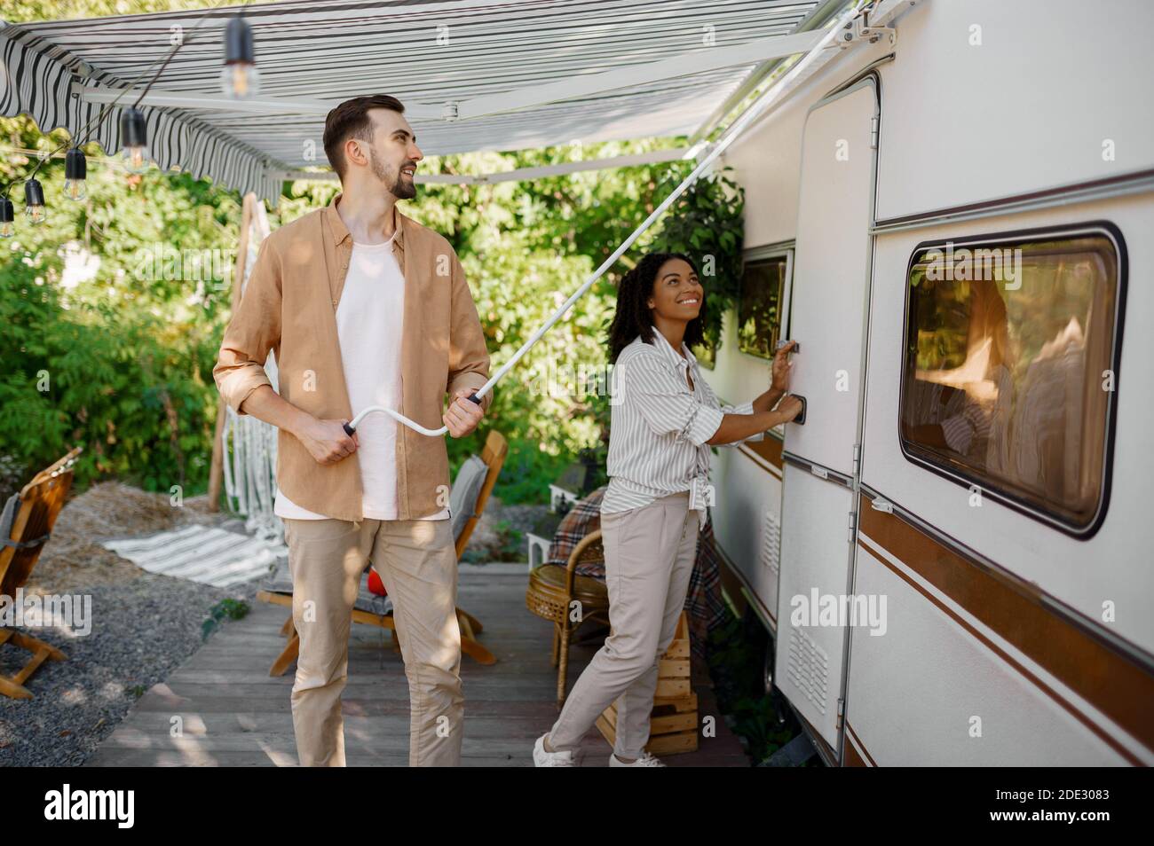 Love couple sets rv tent, camping in a trailer Stock Photo - Alamy