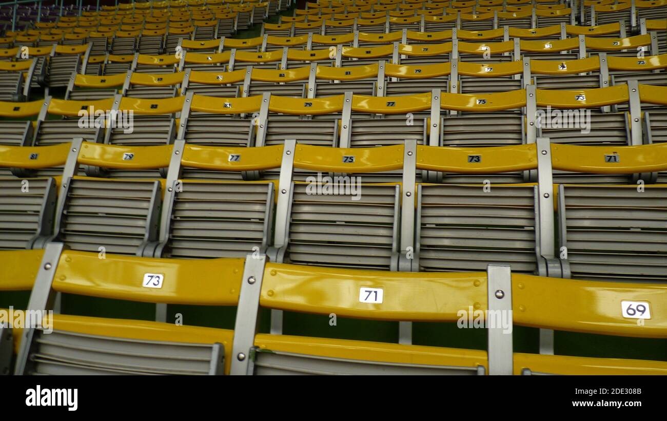 Yellow stadium seats with numbers Stock Photo - Alamy