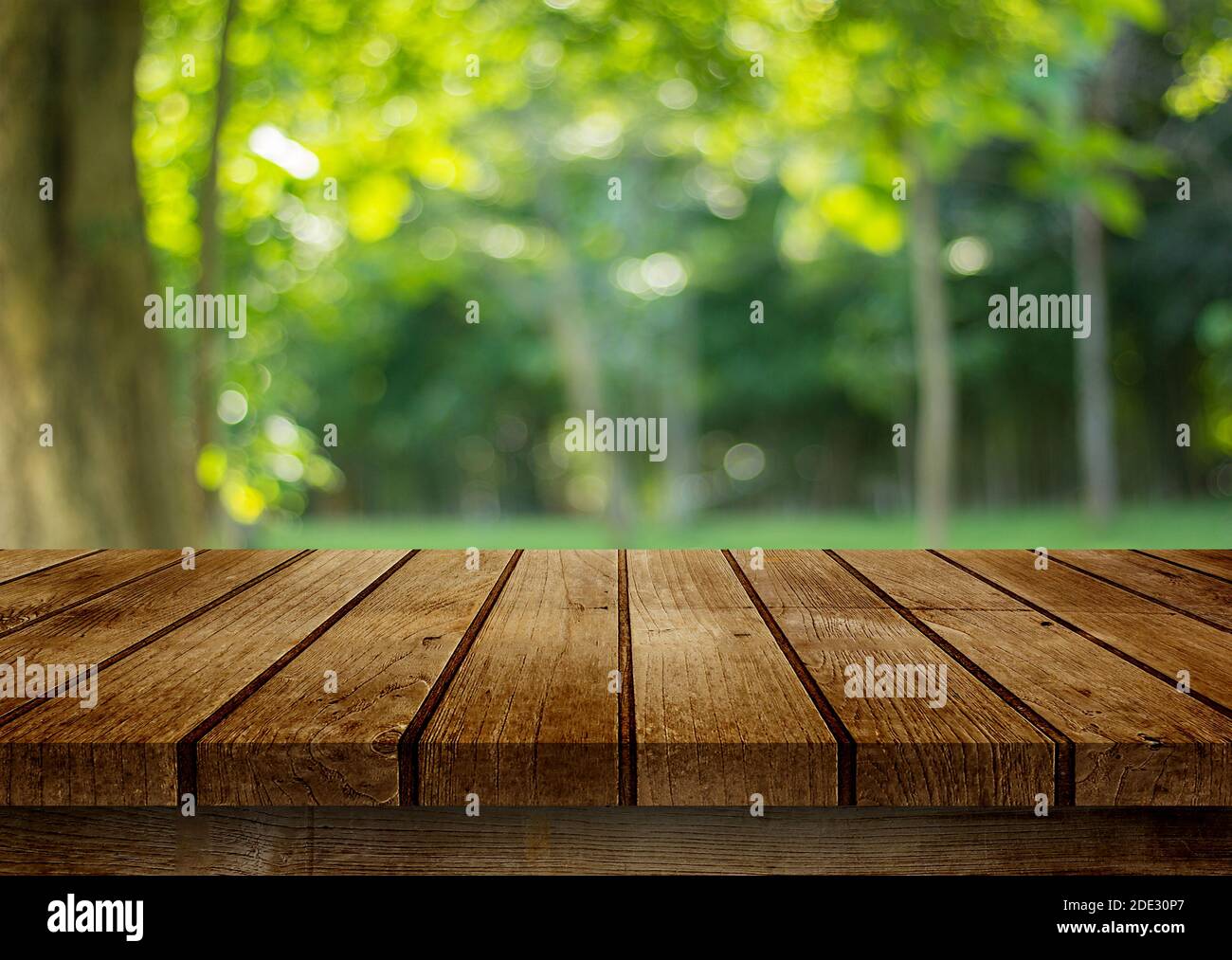 Wood floor with blurred trees of nature park background and summer ...
