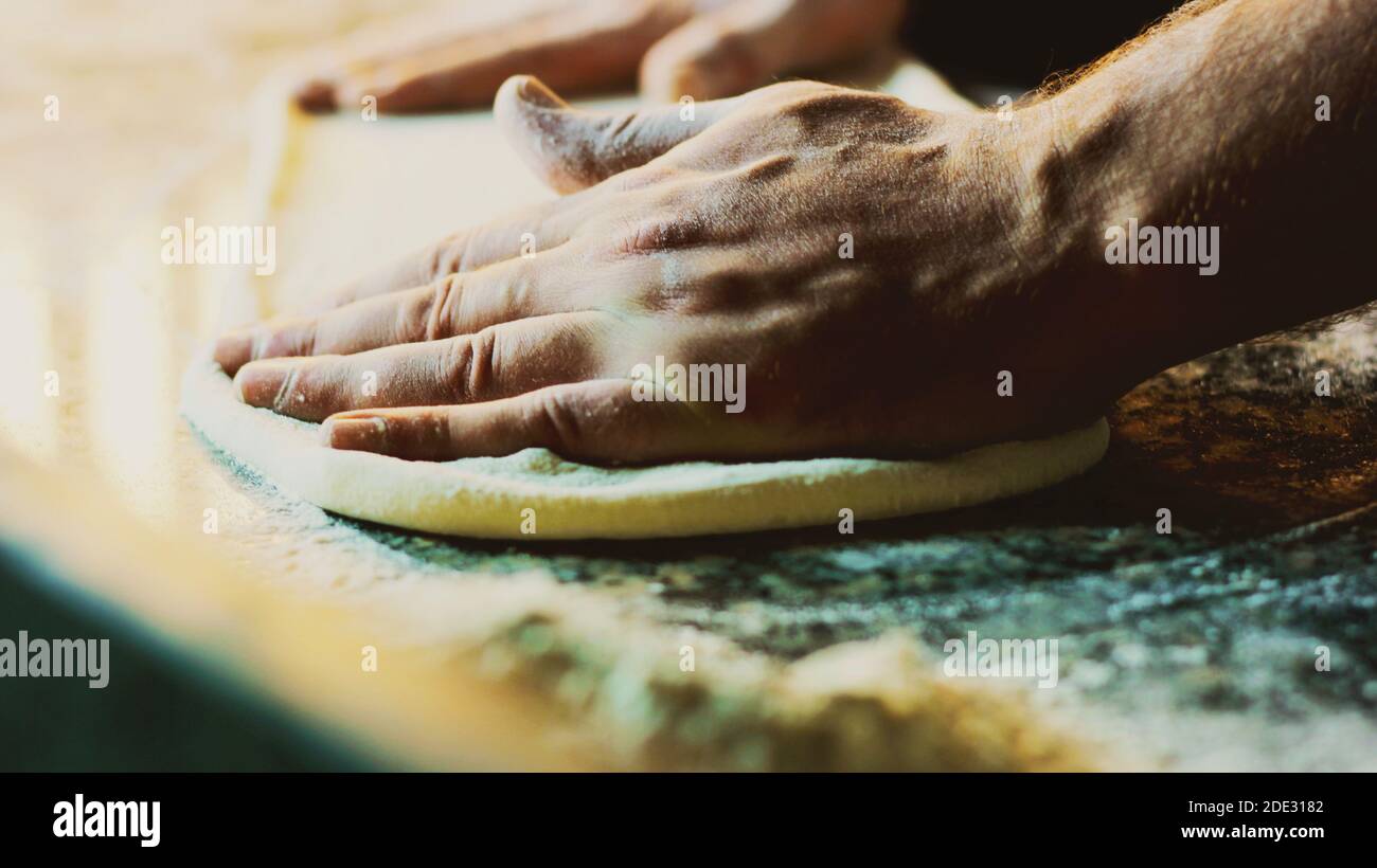 hands of pizza chef prepares pizza on workbench Stock Photo - Alamy
