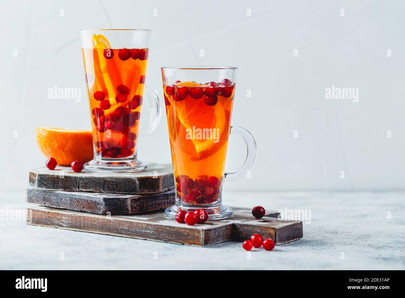 Hot tea with orange slices and cranberries in glass tall glasses. Hot ...