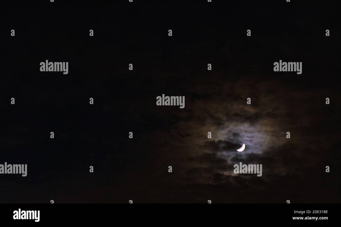 half moon cover by cloud in night Stock Photo - Alamy