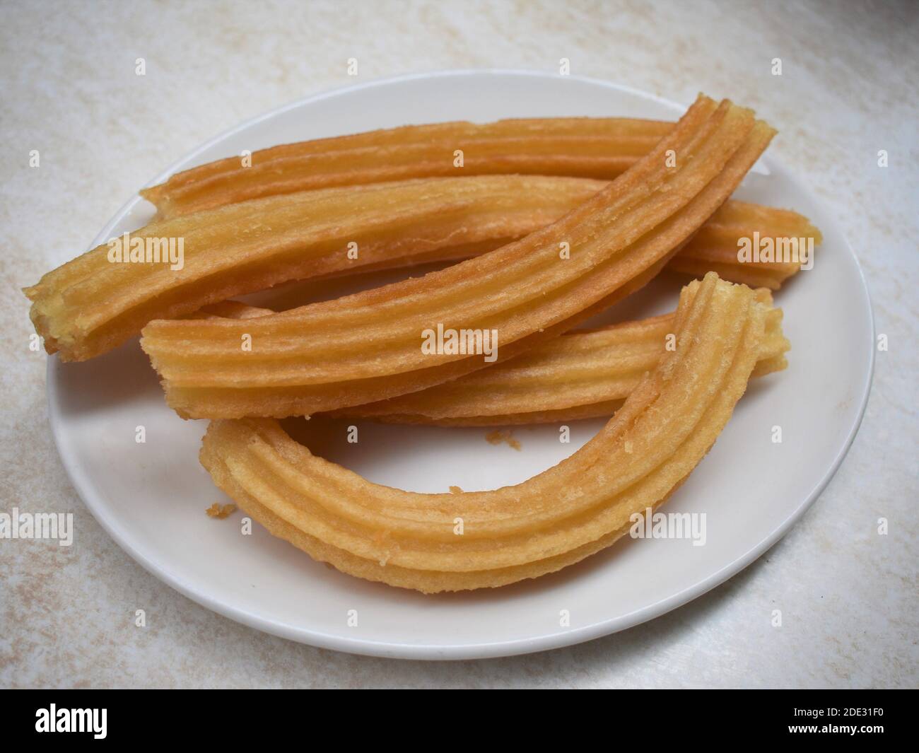 Typical plate of churros freshly made Stock Photo - Alamy