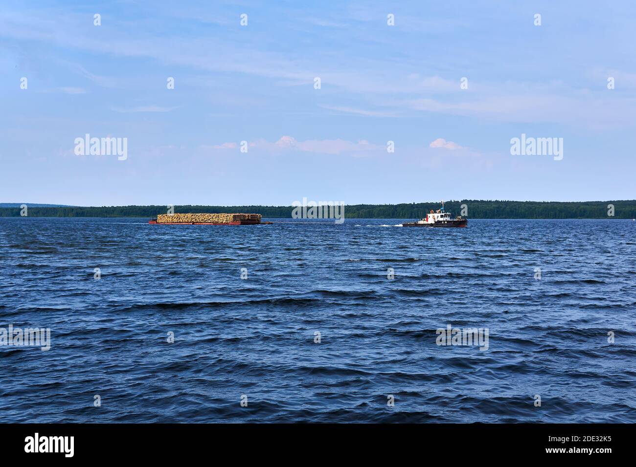 transportation of timber along the river using a barge towed by a tug ...