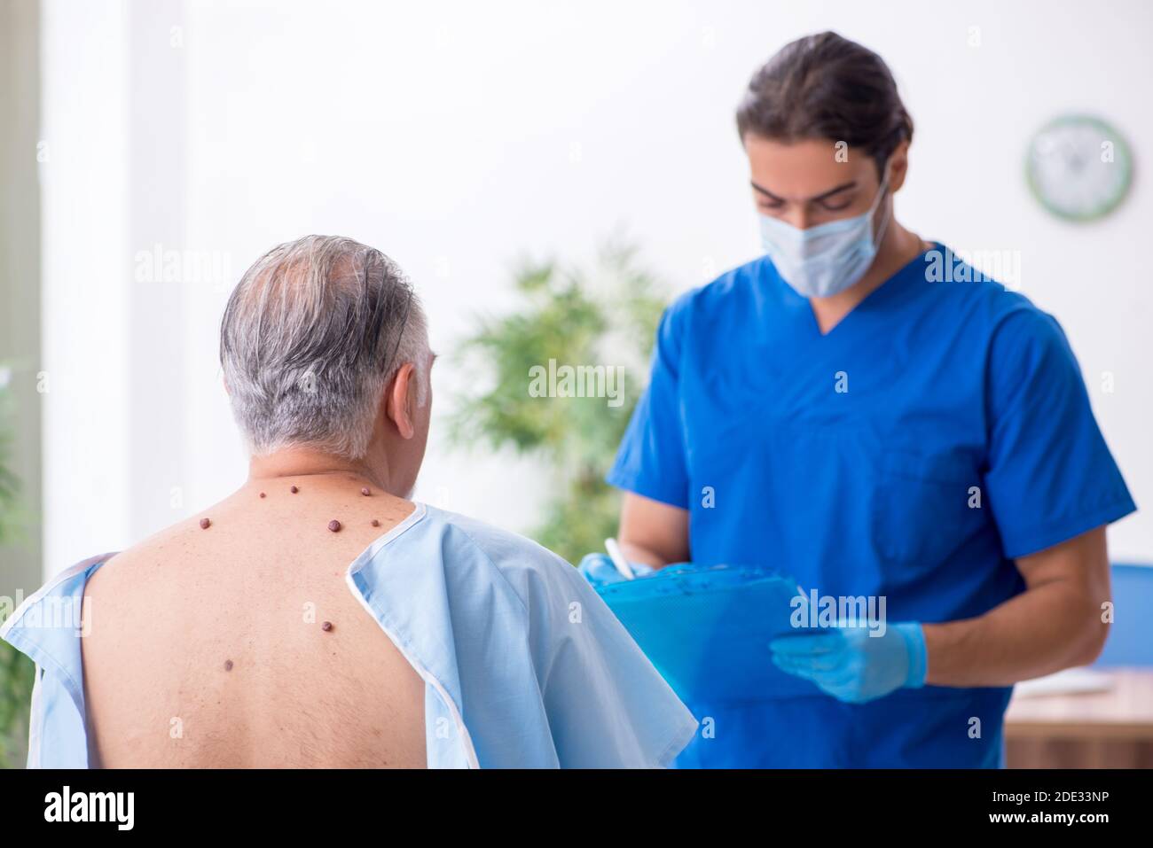 Old man visiting male doctor dermatologist Stock Photo - Alamy