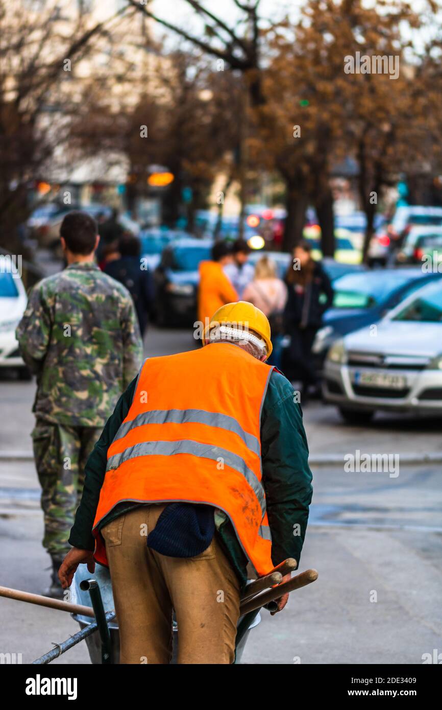 Back view of construction worker wearing reflective vest preparing for ...