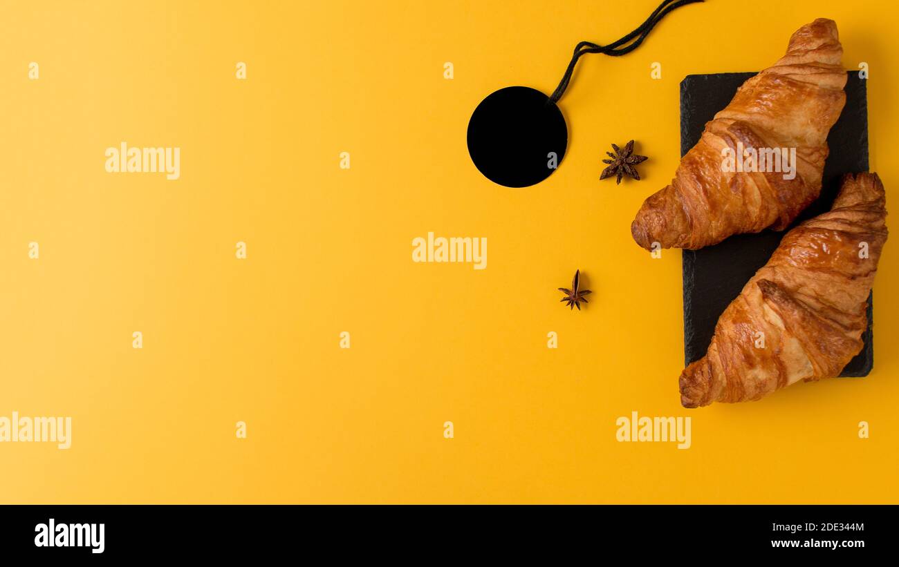 A top view of croissant bread with star anise isolated on yellow ...