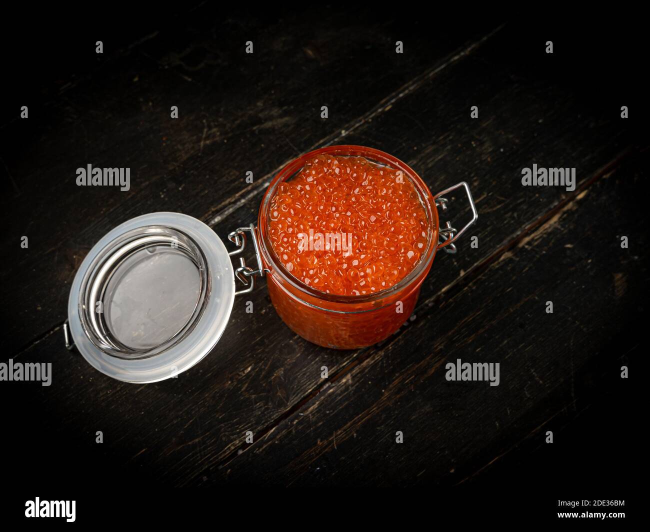 Pink salmon caviar in a glass jar. Seafood, delicacies, healthy ...