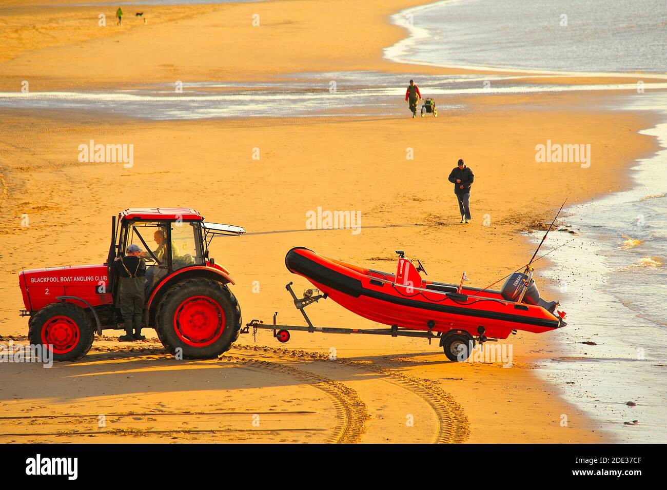 Red tractor launching red speed boat off St Annes beach Stock Photo - Alamy