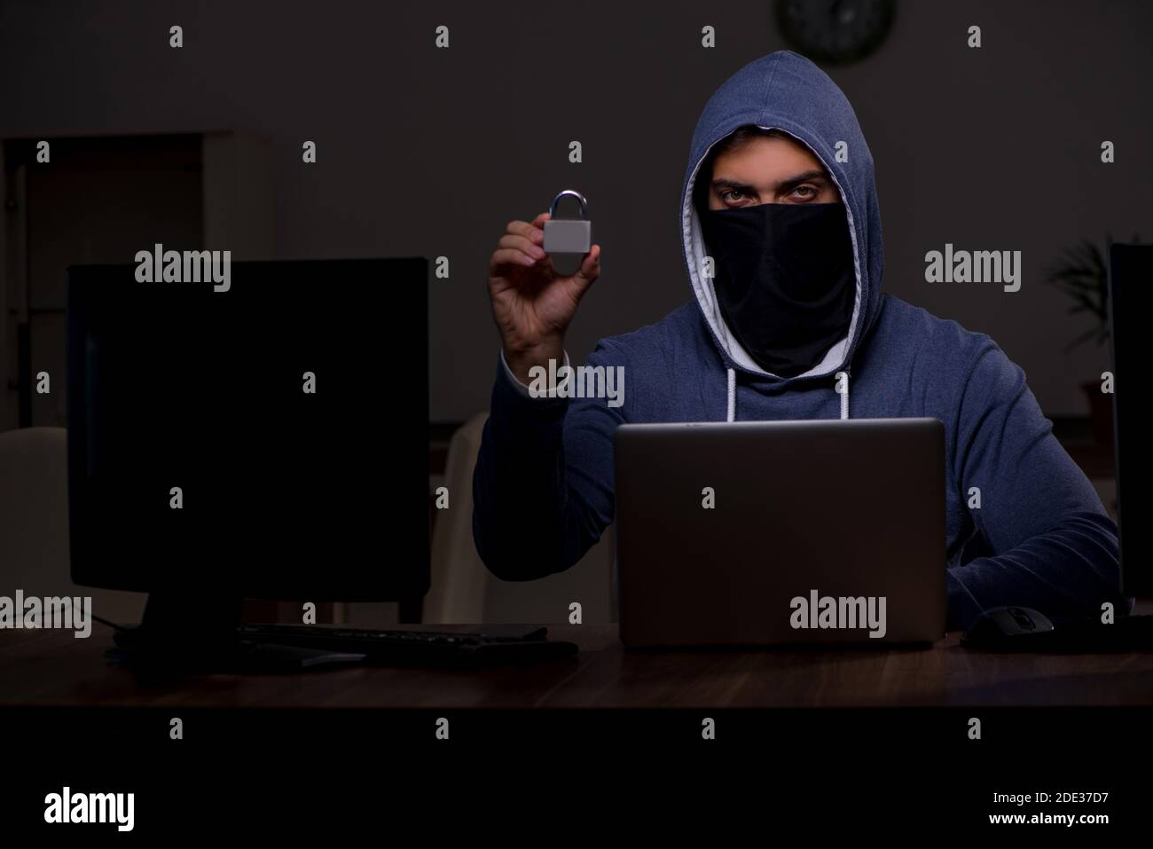 Male hacker hacking security firewall late in the office Stock Photo ...